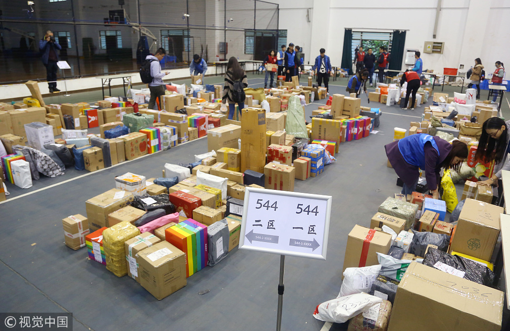 College students collect packages in the gym after the Singles' Day ...