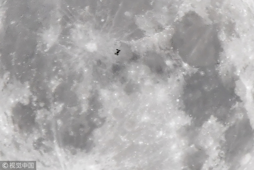 ISS against moon reminiscent of E.T. scene - China Plus